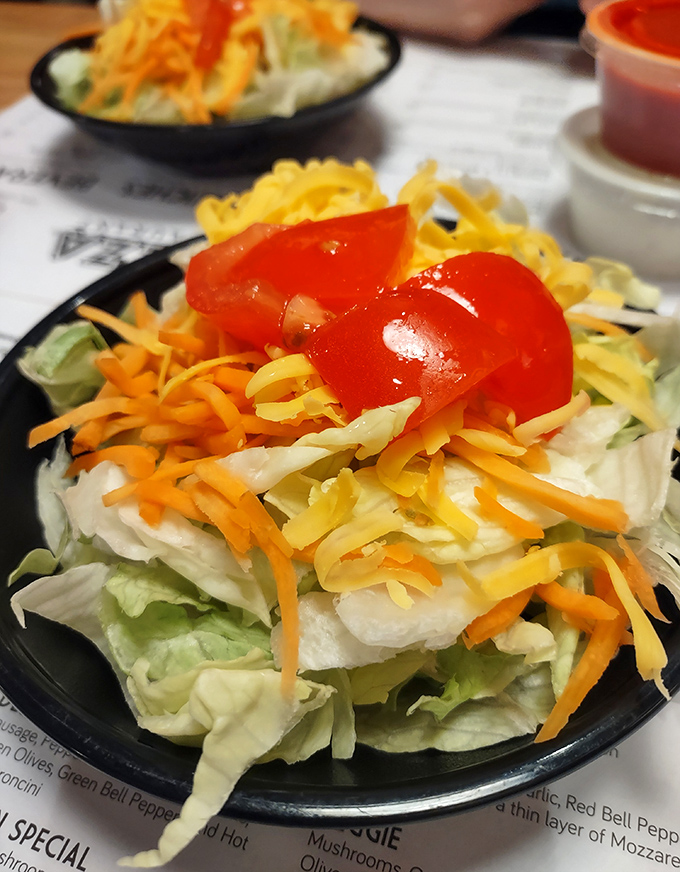 A salad at a pizza place that actually deserves attention. Crisp, colorful, and not just the obligatory green thing you order to feel virtuous before demolishing a pizza.