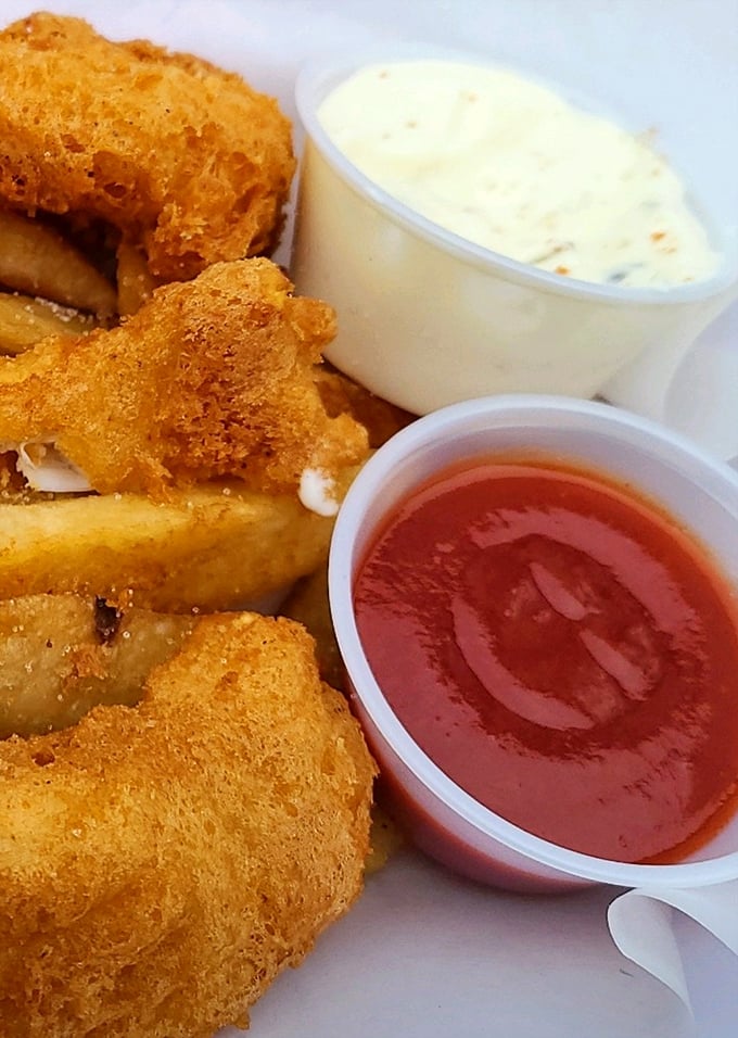 Look at that perfect golden crust! Like edible sunshine, these morsels reveal flaky white fish beneath their crispy armor.