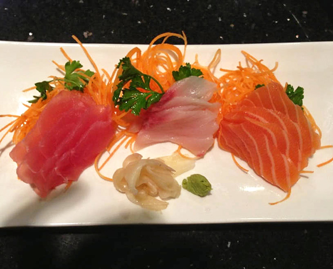 Fresh sashimi arranged with the precision of a jeweler, each slice promising an ocean of flavor in a single bite.