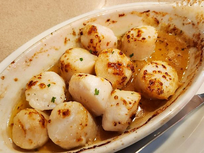 These scallops aren't just cooked, they're respected &ndash; perfectly caramelized and swimming in butter that should be illegal in at least seven states.