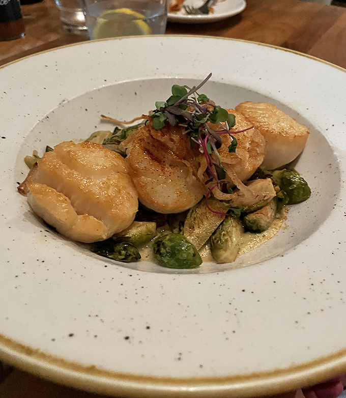 Plump, golden scallops nestled among Brussels sprouts &ndash; proof that sometimes the simplest preparations yield the most divine results.