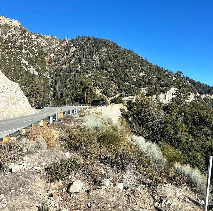 Mother Nature's own version of a winding staircase. The road hugs the mountainside like it's afraid of heights&mdash;ironically.