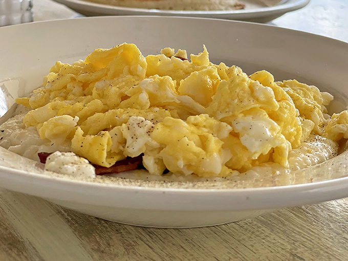 These scrambled eggs aren't just cooked—they're coaxed into fluffy, buttery submission. The breakfast equivalent of a perfect morning where everything goes right.