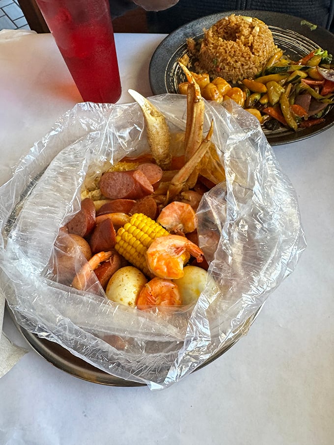 The classic seafood boil in all its glory: shrimp, sausage, corn, and potatoes mingling in a plastic-lined bowl while hibachi waits in the wings.