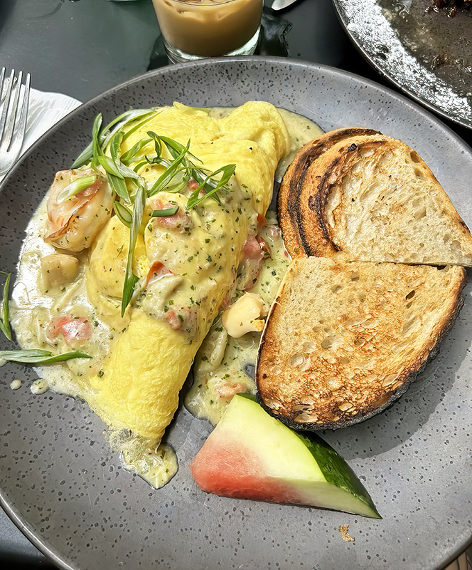 This isn't just an omelet&mdash;it's a seafood symphony on a plate, with perfectly toasted bread standing by for the inevitable "clean your plate" moment.