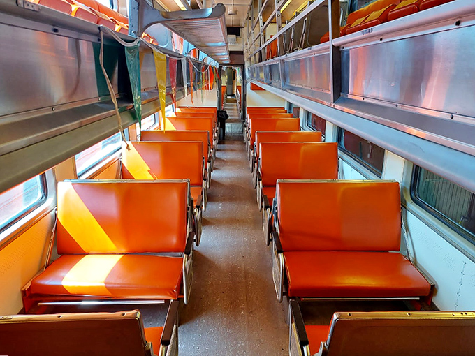 Tangerine-hued seats line up like dutiful soldiers, ready to cradle travelers through miles of North Shore splendor.