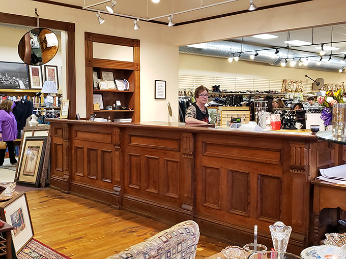 The beautifully preserved wooden counter speaks to the building's history, while friendly volunteers create the warm, community atmosphere that defines the shop.