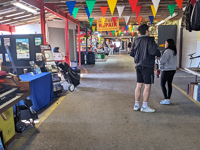 Rows of colorful banners guide shoppers through this retail wilderness, where one person's "I don't need this anymore" becomes another's "I've been looking everywhere!"
