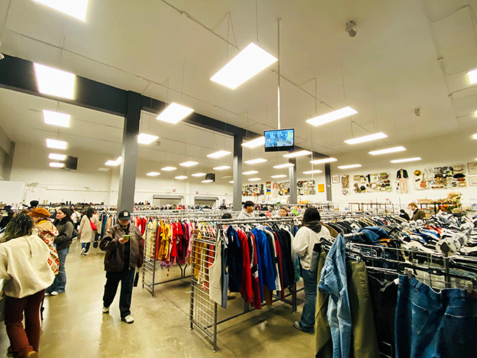 Organized chaos at its finest&mdash;shoppers navigate the clothing forest with practiced eyes, scanning for that needle-in-a-haystack vintage gem.
