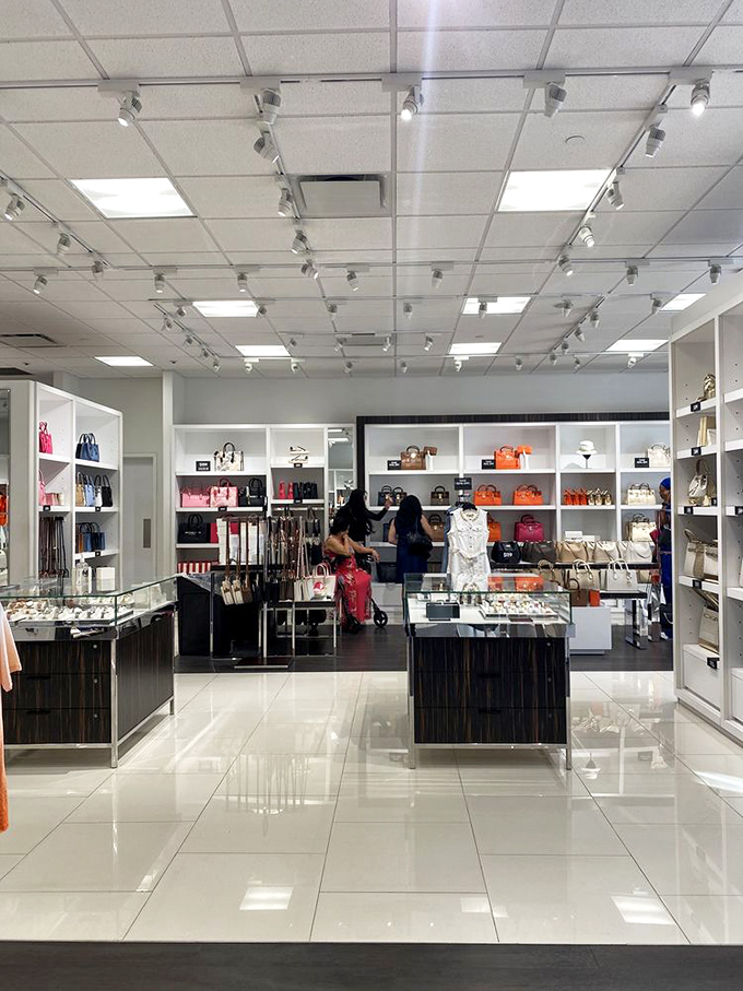 Luxury retail therapy in its natural habitat. Kate Spade's colorful handbag display creates the kind of temptation that credit card limits were made to test.