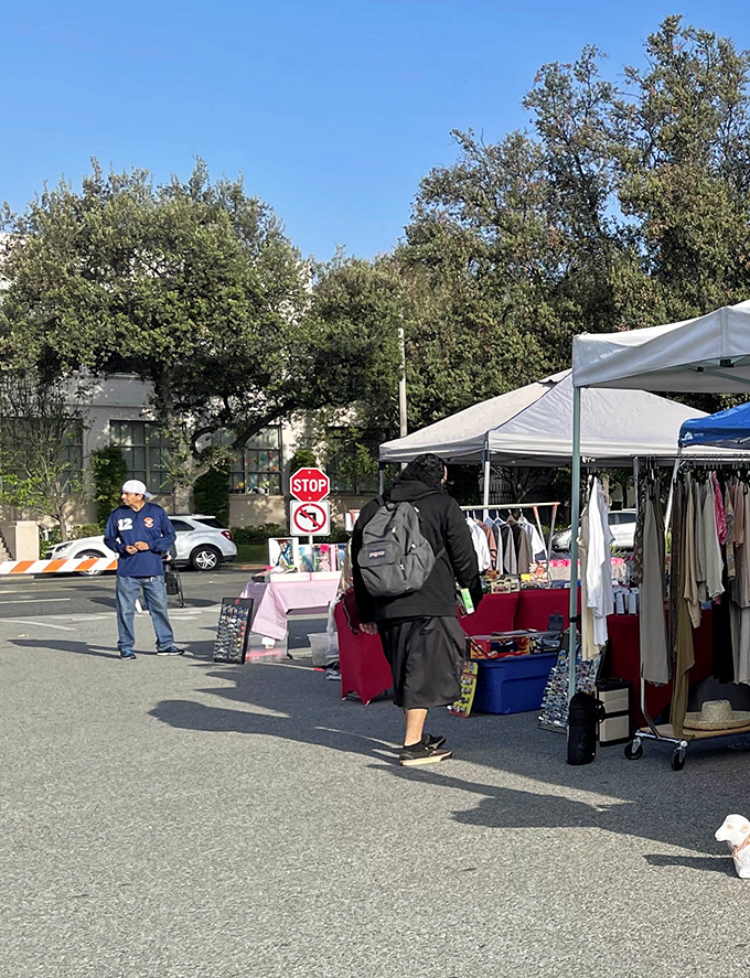 The dance of commerce unfolds as shoppers browse clothing racks, each item waiting for its second act in someone else's wardrobe story.