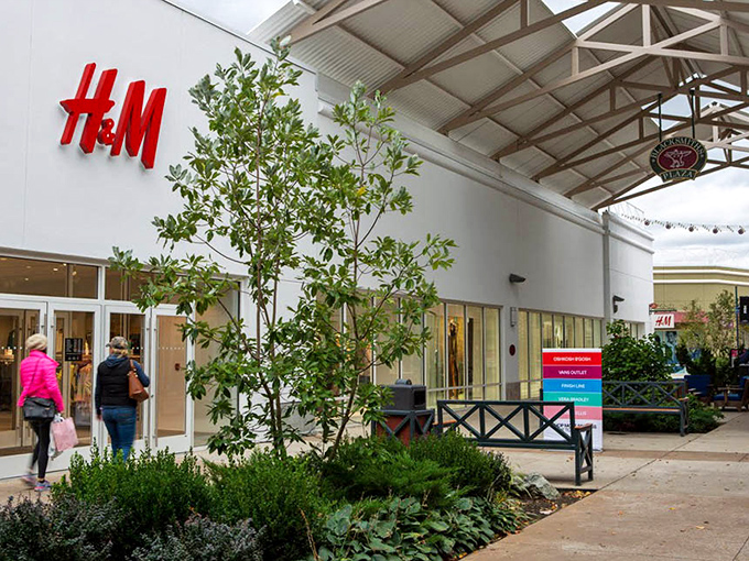 H&M's bold red signage pops against the clean white fa&ccedil;ade, like a siren call to fashion-forward shoppers seeking Scandinavian style without the IKEA assembly required.