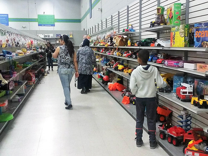 Families navigate the toy aisles together, proving that treasure hunting is an intergenerational sport where everyone can score a win.