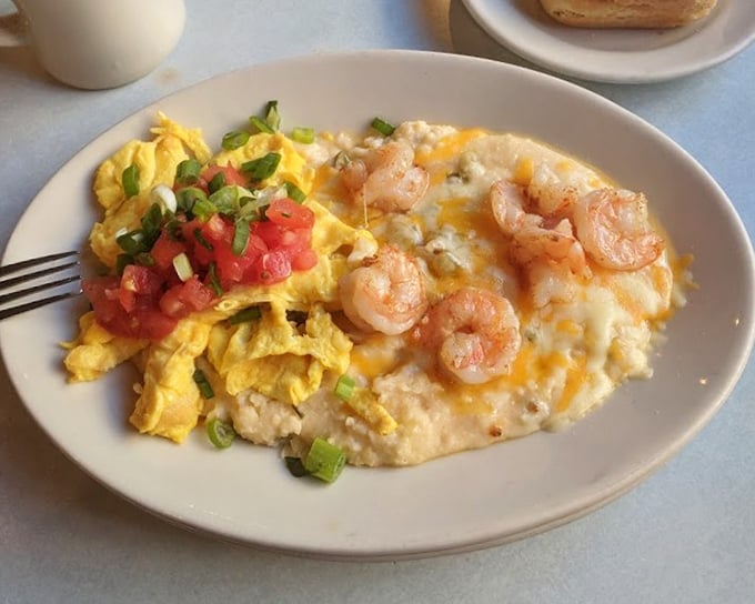 Southern comfort reimagined&mdash;creamy grits playing host to plump shrimp while eggs and fresh tomatoes add pops of color and flavor.