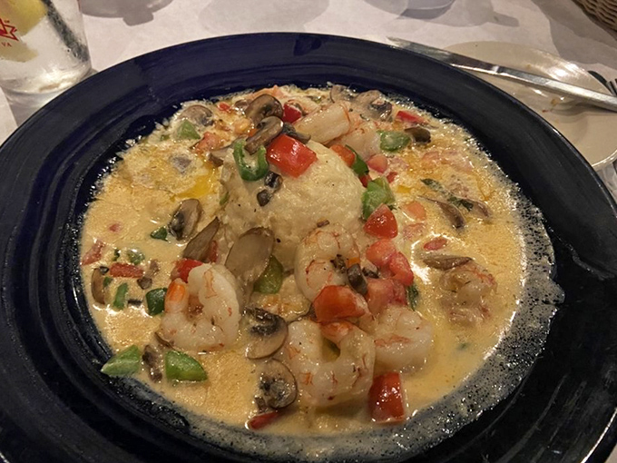 Shrimp and grits elevated to an art form &ndash; plump shrimp swimming in creamy goodness with colorful vegetables playing supporting roles.