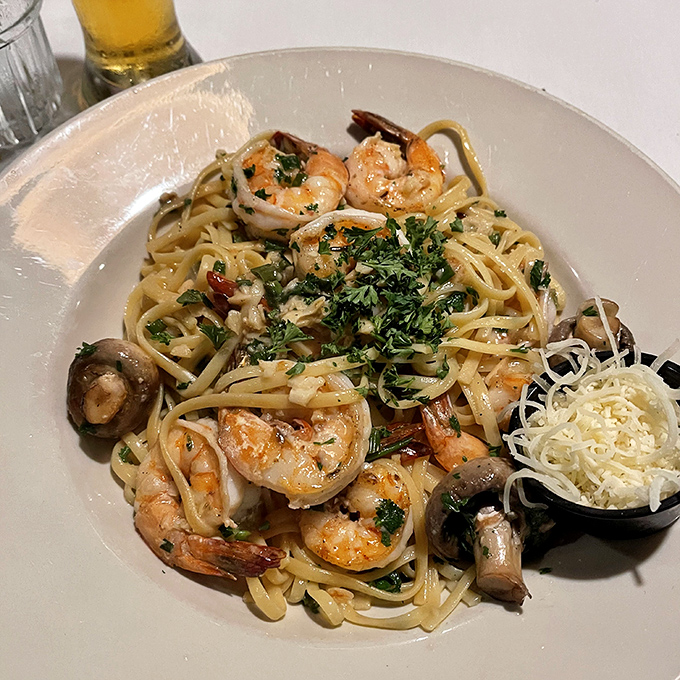 Shrimp and scallops dancing with mushrooms in a buttery sauce over pasta—proof that sometimes the simplest combinations create the most profound flavors.