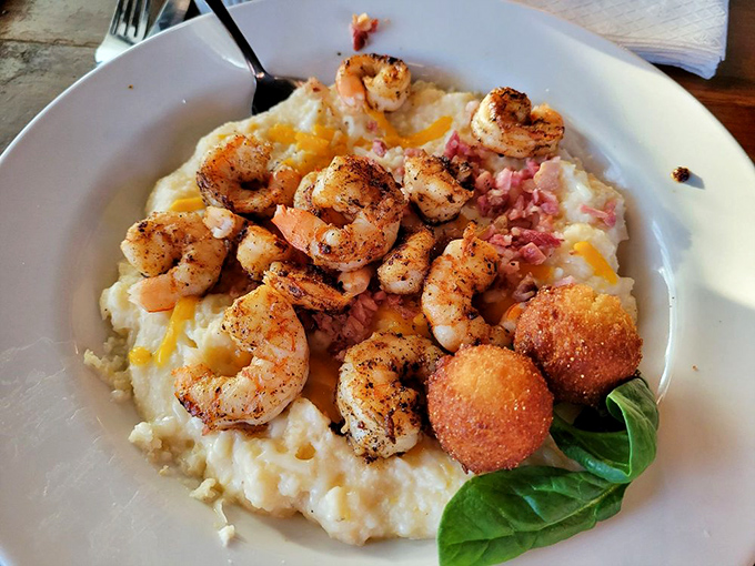 Shrimp and grits elevated to an art form &ndash; plump Georgia shrimp nestled on cheesy grits with what appears to be a hush puppy standing guard.