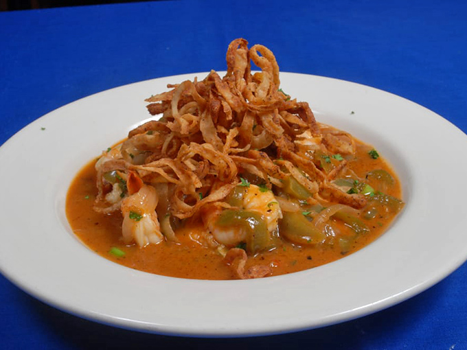 Shrimp and grits elevated to an art form. Those crispy onions aren't just garnish&mdash;they're the exclamation point on a Southern classic reimagined. 