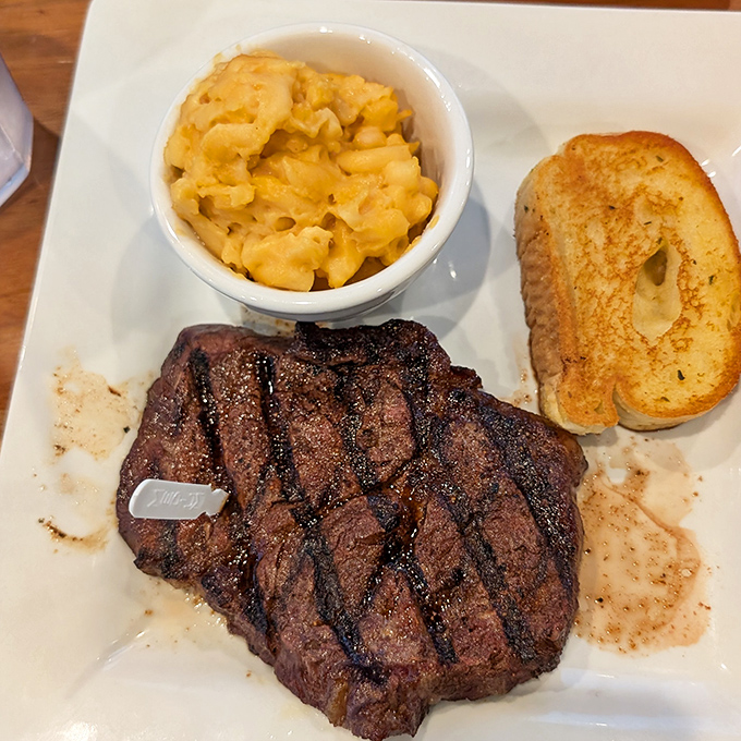 The holy trinity of steakhouse perfection: a perfectly cooked sirloin, mac and cheese that would make your childhood self weep with joy, and garlic toast for sopping up every last drop.