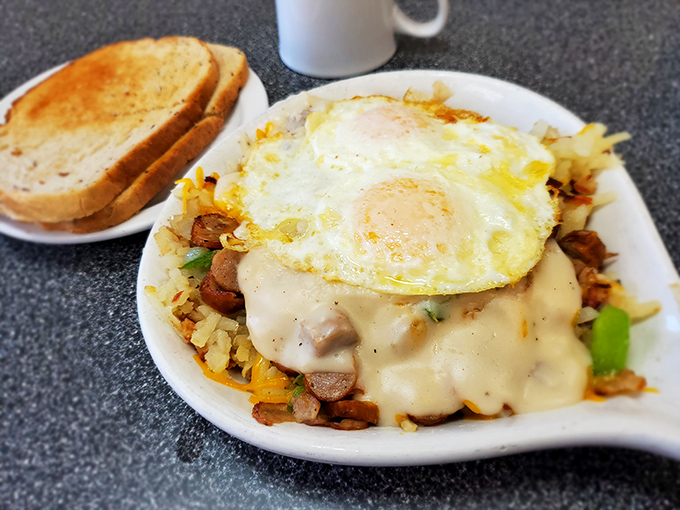 Breakfast alchemy at its finest&mdash;potatoes transformed into golden hash browns, crowned with eggs and smothered in cheese that stretches with each forkful.