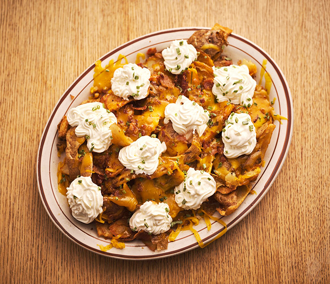 Loaded potato skins crowned with whipped cream rosettes&mdash;proof that sometimes the best culinary ideas sound completely absurd until you taste them.