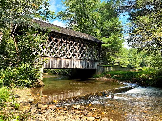 Covered bridges whisper stories of simpler times while the creek babbles its endless mountain song below.