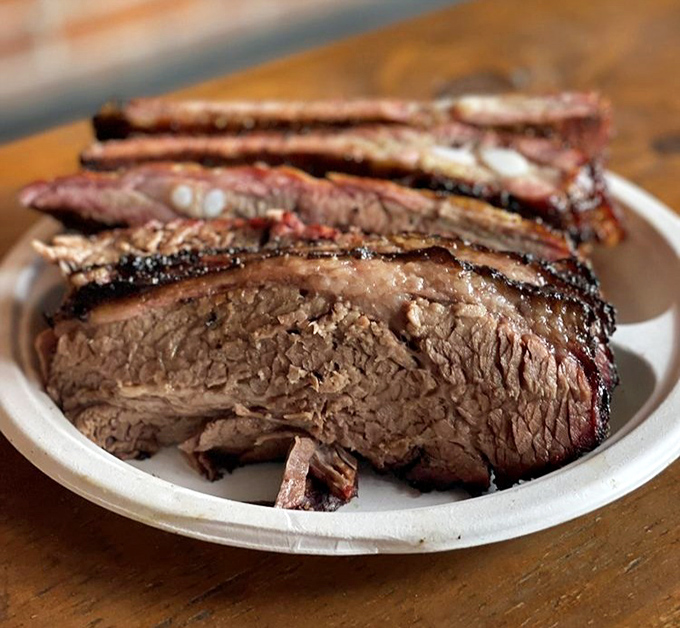 Brisket sliced thick enough to make a Texan nod in approval. That smoke ring isn't just for show&mdash;it's a flavor halo.