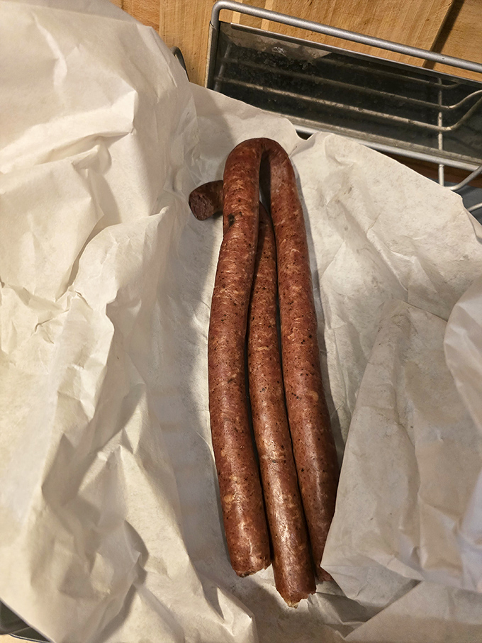Behold the star attraction: kielbasa links curved like a smile, promising smoky, garlicky bliss with each satisfying snap of the casing.
