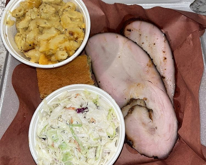 Smoked turkey that defies the "dry poultry" curse, flanked by mac and cheese and slaw. This plate is the United Nations of comfort food.
