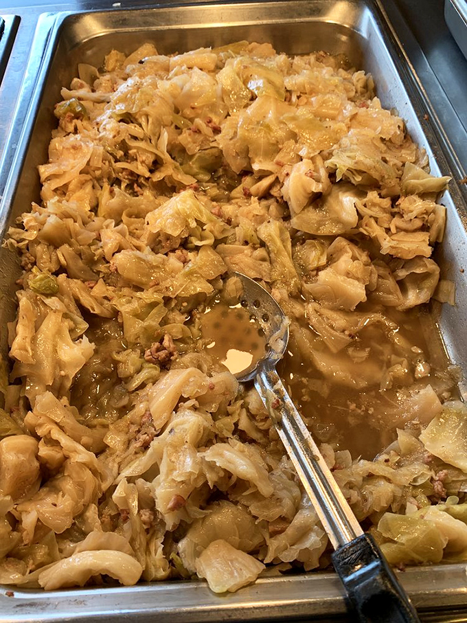 Smothered cabbage that grandmothers across Louisiana would approve of, swimming in pot liquor that deserves to be sopped up with cornbread.