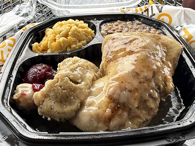 Smothered chicken swimming in gravy alongside mac and cheese and beans. When comfort food gets its PhD, this is the dissertation.