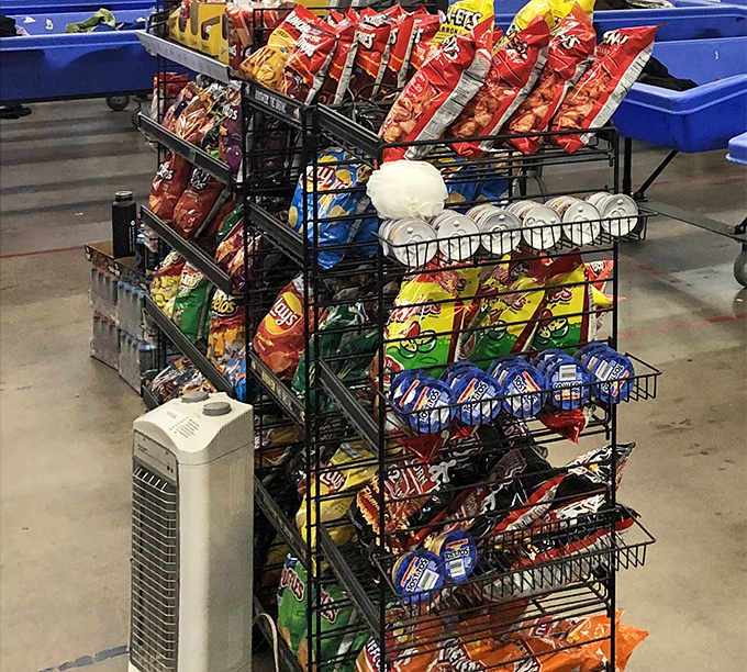 Even treasure hunters need fuel! The snack rack stands sentinel between bargain bins, offering sustenance for the marathon shoppers.