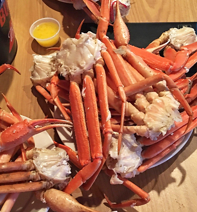 Snow crab legs arranged like a maritime masterpiece, with butter standing by for its supporting role in this oceanic drama.