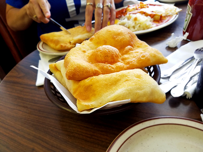 Fresh sopapillas arrive puffy and golden, ready to be drizzled with honey or torn open for that perfect sweet-savory contrast.