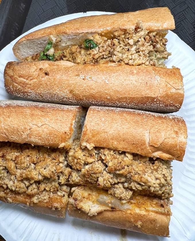 The spicy chicken cheesesteak &ndash; where traditional Philly meets bold international flavors. That golden-brown roll is practically begging to be devoured.
