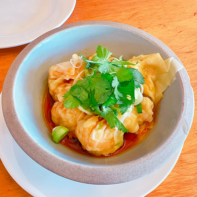 These shrimp wontons aren't just dumplings—they're little flavor bombs waiting to detonate. Delicate wrappers, plump filling, and a sauce that makes you consider drinking the remaining drops.