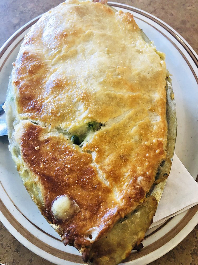 This isn't just a spinach pie&mdash;it's a golden-crusted treasure chest filled with savory delights that would make Popeye weep with joy. 