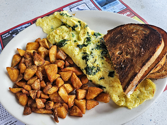 A spinach omelet that actually makes you want to eat your greens, paired with home fries that could convert a hash brown loyalist.