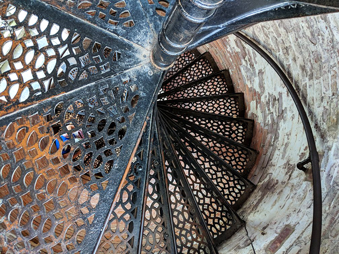 The spiral staircase inside reveals the lighthouse's beautiful bones&mdash;77 steps of wrought-iron artistry that have carried keepers skyward since the 1800s.