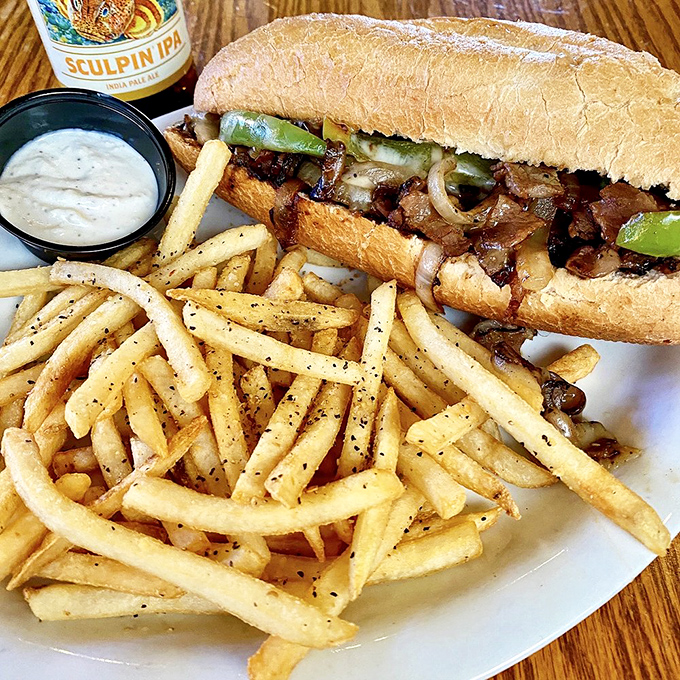 The legendary steak sandwich in all its glory&mdash;tender beef, caramelized onions, and perfectly toasted bread. A symphony of simplicity that hits all the right notes.