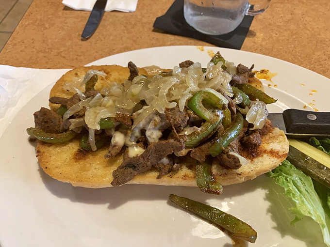 This open-faced steak sandwich isn't messing around. Tender beef, grilled peppers, and onions create a flavor symphony that would make even a cowboy poet.