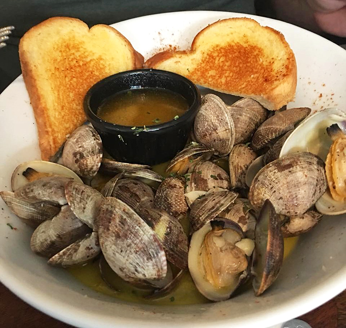 These steamed clams aren't just dinner—they're a treasure hunt where everyone wins. The buttery broth alone deserves its own fan club.