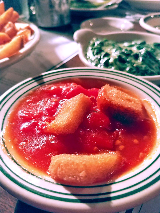 The legendary stewed tomatoes &ndash; sweet, savory, and somehow transformative. Like your grandmother's recipe, if your grandmother was a culinary genius.