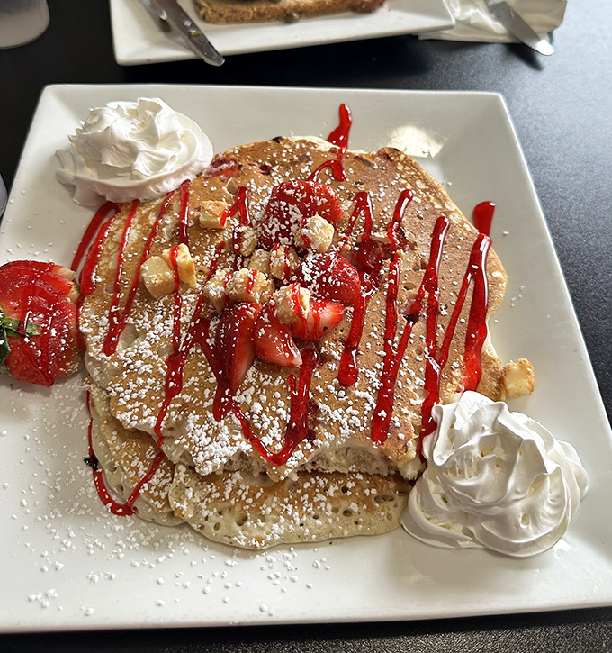 Strawberry pancakes that don't whisper "good morning"&mdash;they sing it with a full choir backup. The whipped cream dollops are just showing off.
