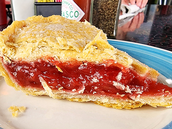 Pie that stops conversation mid-sentence. The ruby-red strawberry rhubarb filling and flaky crust create the perfect sweet-tart balance that defines Midwestern dessert mastery.