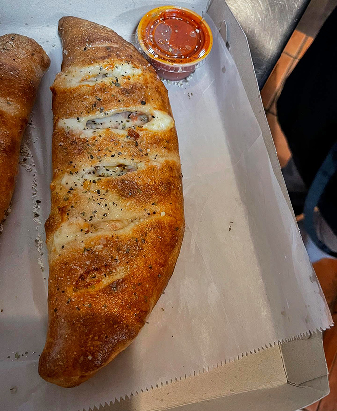 The star of the show &ndash; a golden-brown stromboli that's essentially edible architecture, with marinara for dipping.