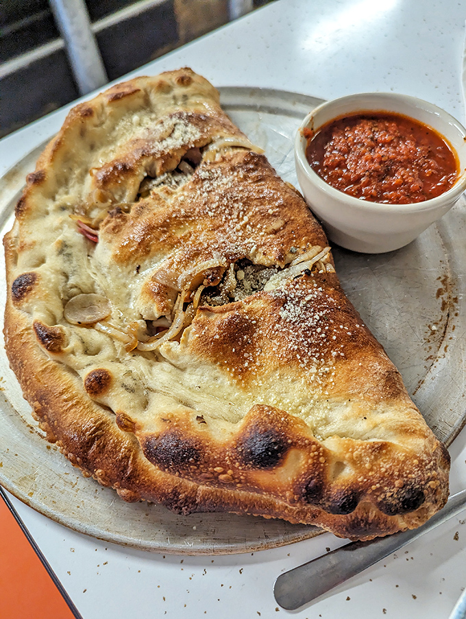 This stromboli isn't just folded dough &ndash; it's an edible envelope delivering a message of cheesy, savory bliss straight to your soul.