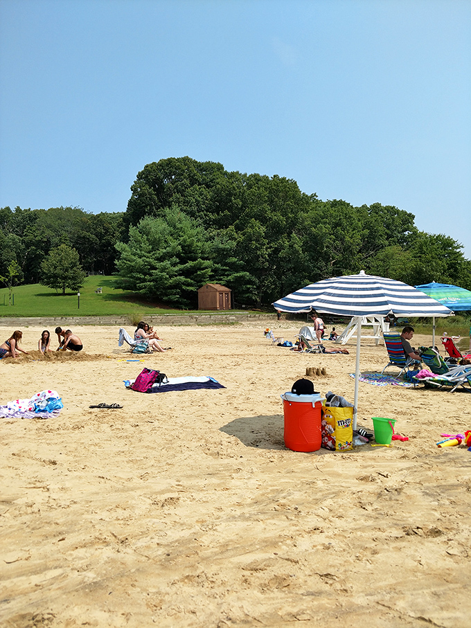 Beach day bliss under blue skies. Nothing says "I'm ignoring Monday's existence" quite like a colorful umbrella and warm sand between your toes.
