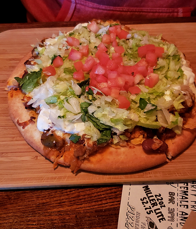 The Taco Pizza proves Whitey's refuses to be pigeonholed, topped with fresh lettuce and diced tomatoes on a perfectly crisp crust.
