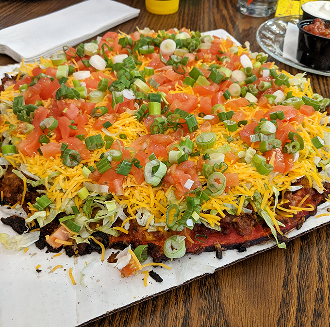 Taco Tuesday meets Pizza Night in this colorful creation. The fresh scallions and tomatoes add a brightness that cuts through the richness perfectly.